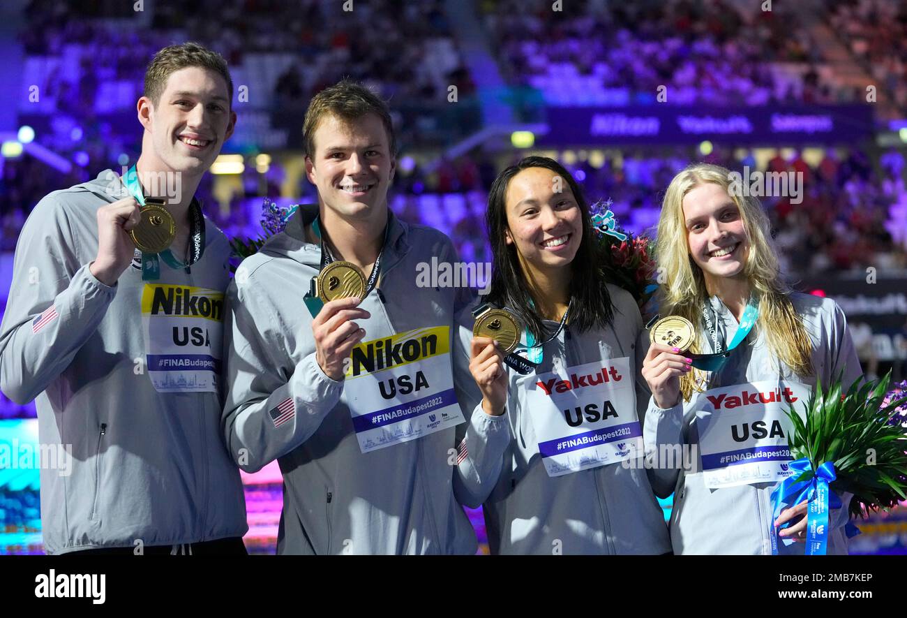 United States team pose with their gold medals after the Mixed 4x100m ...