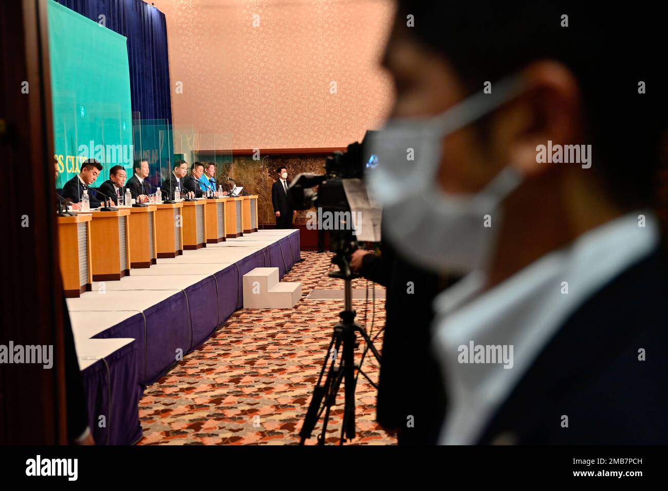 A security guard watches the debate by political parties' leaders ...