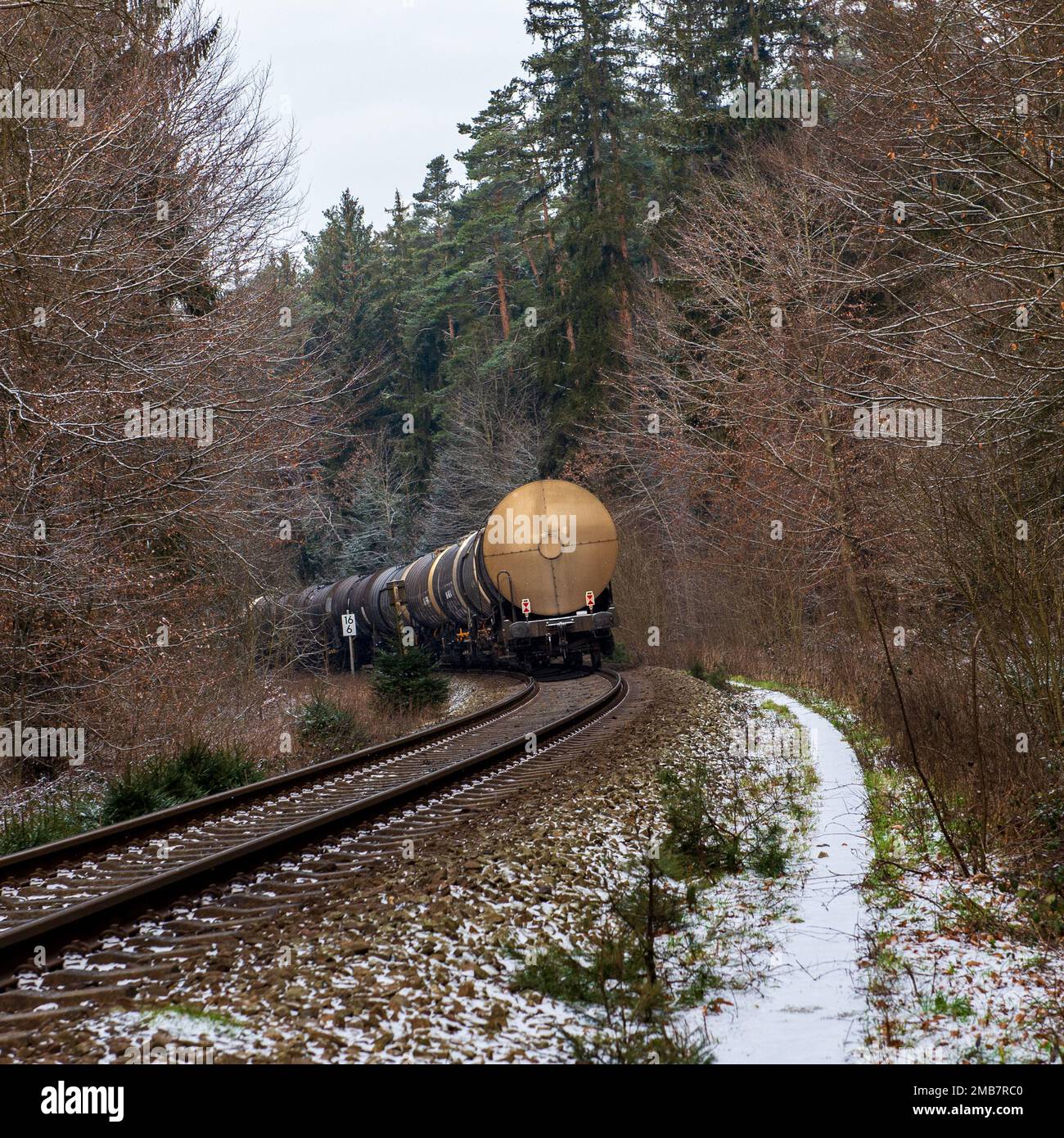 A freight train transporting oil from a refinery makes its way through ...