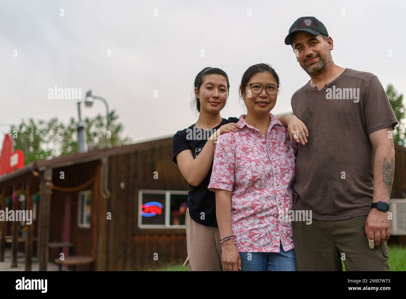Yokie Johnson, center, stands with her husband, Lee , and their ...