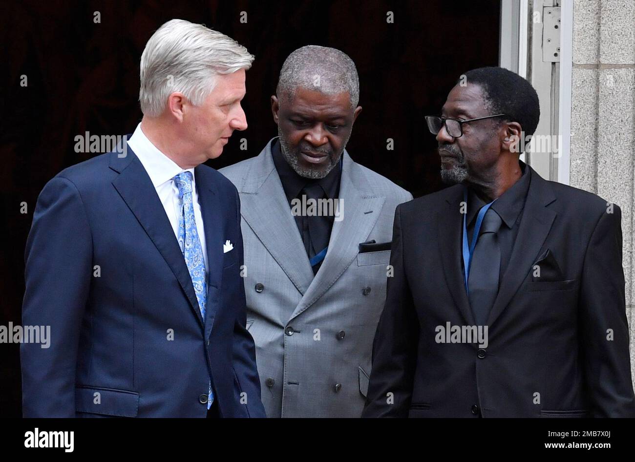 Belgium's King Philippe, left, speaks with the children of Congo's ...