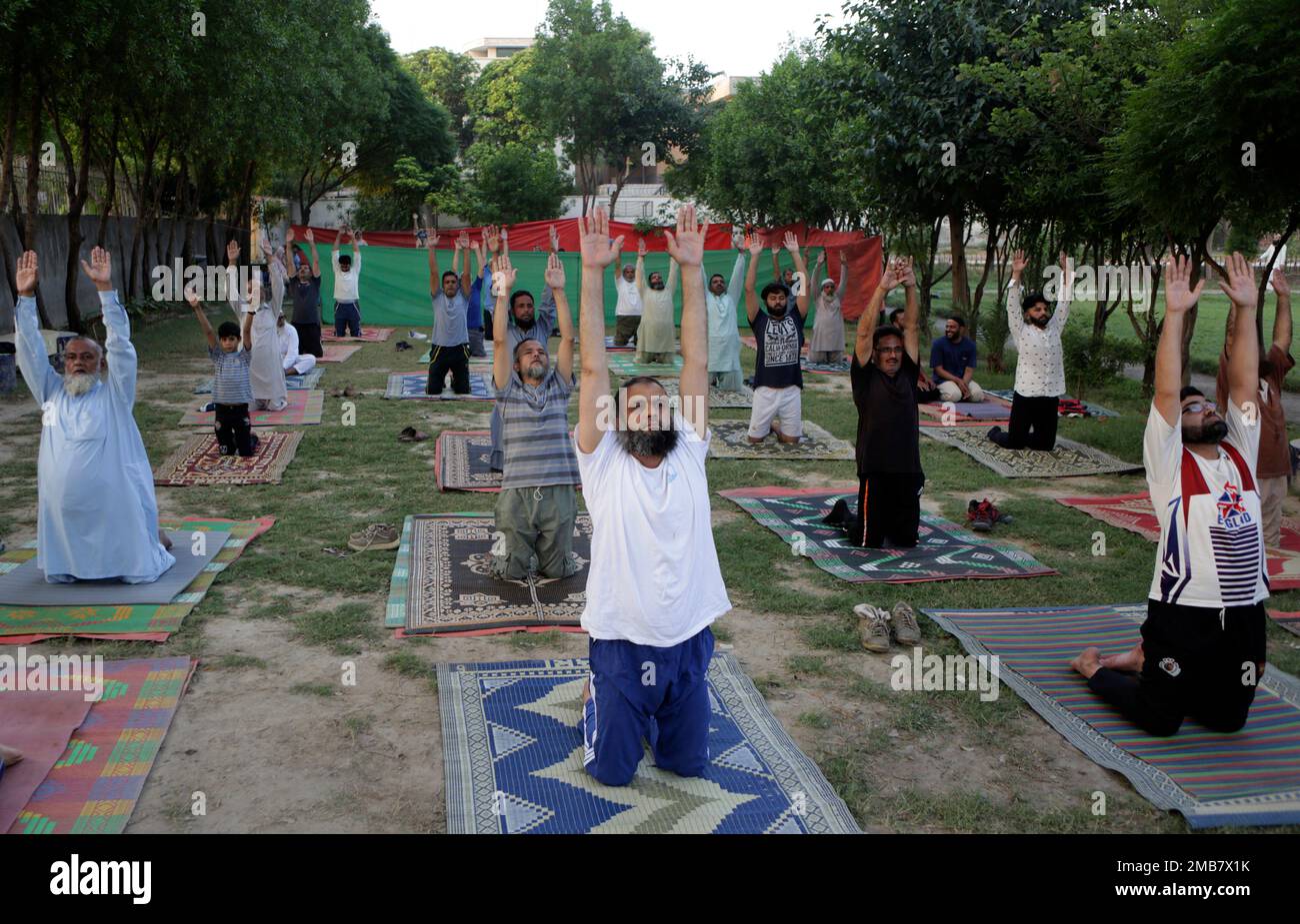 Several people practice yoga during the celebration of the ...