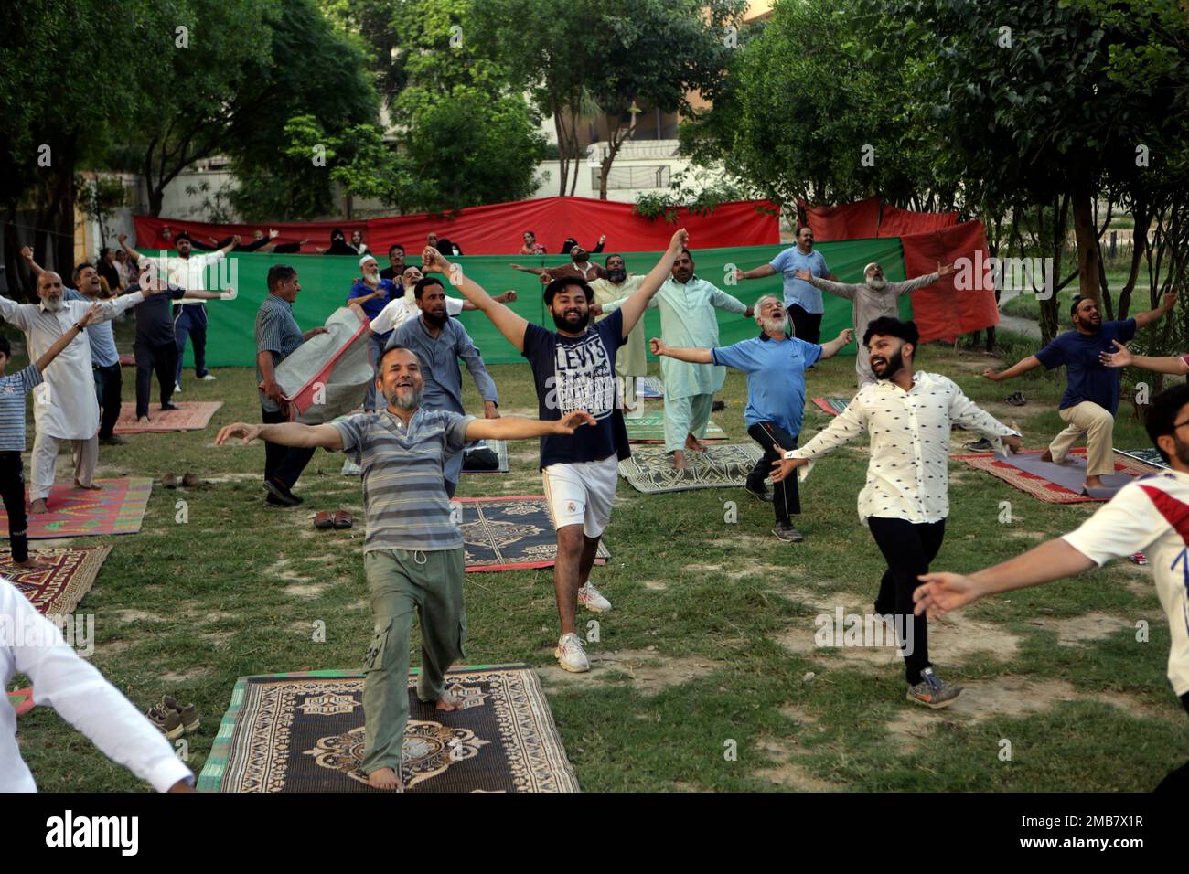Several people practice yoga during the celebration of the ...