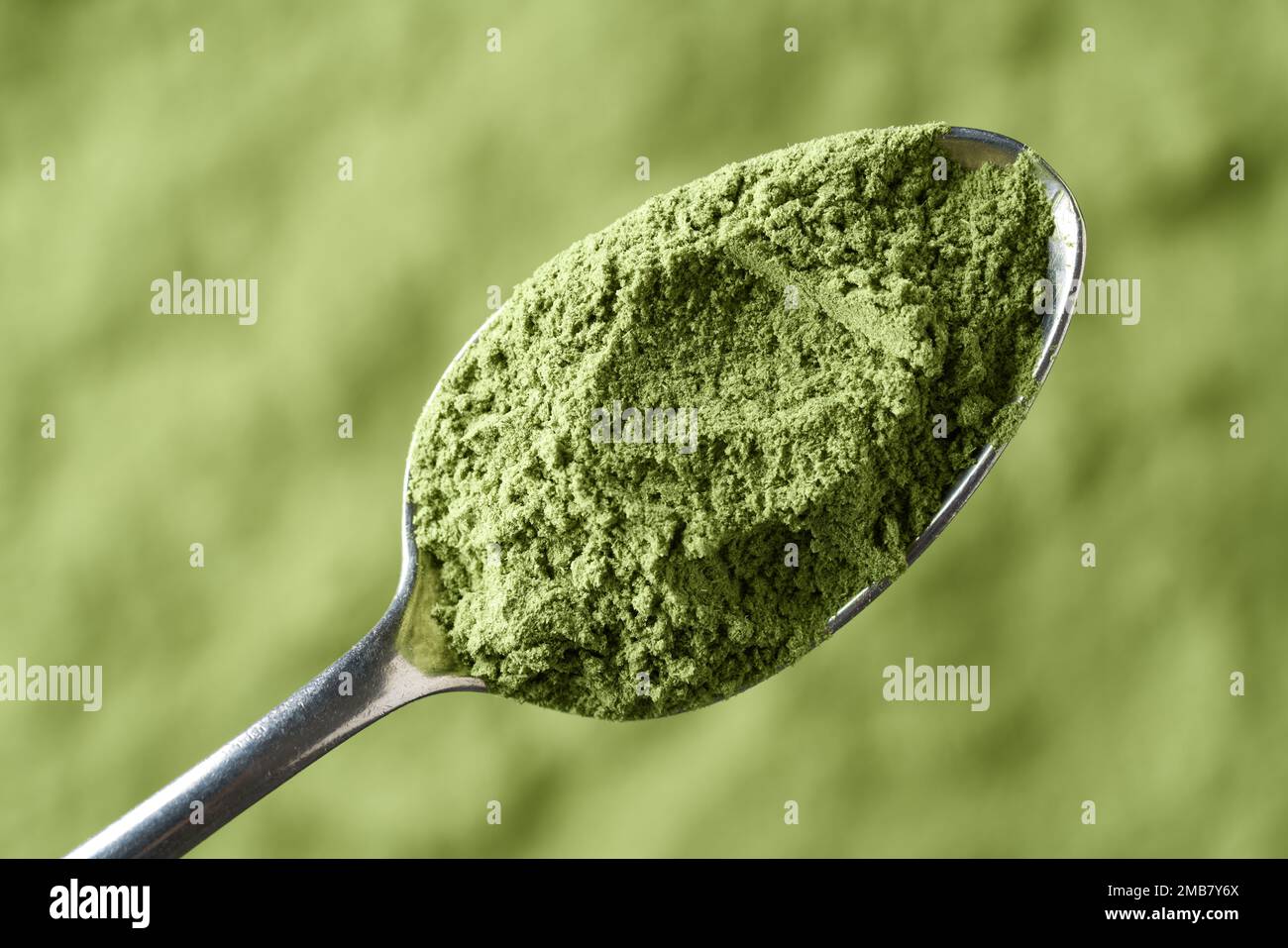 Barley grass powder on a spoon, top view Stock Photo - Alamy