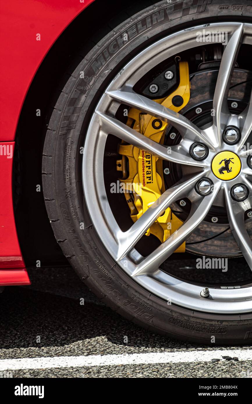 A vertical closeup shot of the wheel of a red Ferrari sports car Stock ...