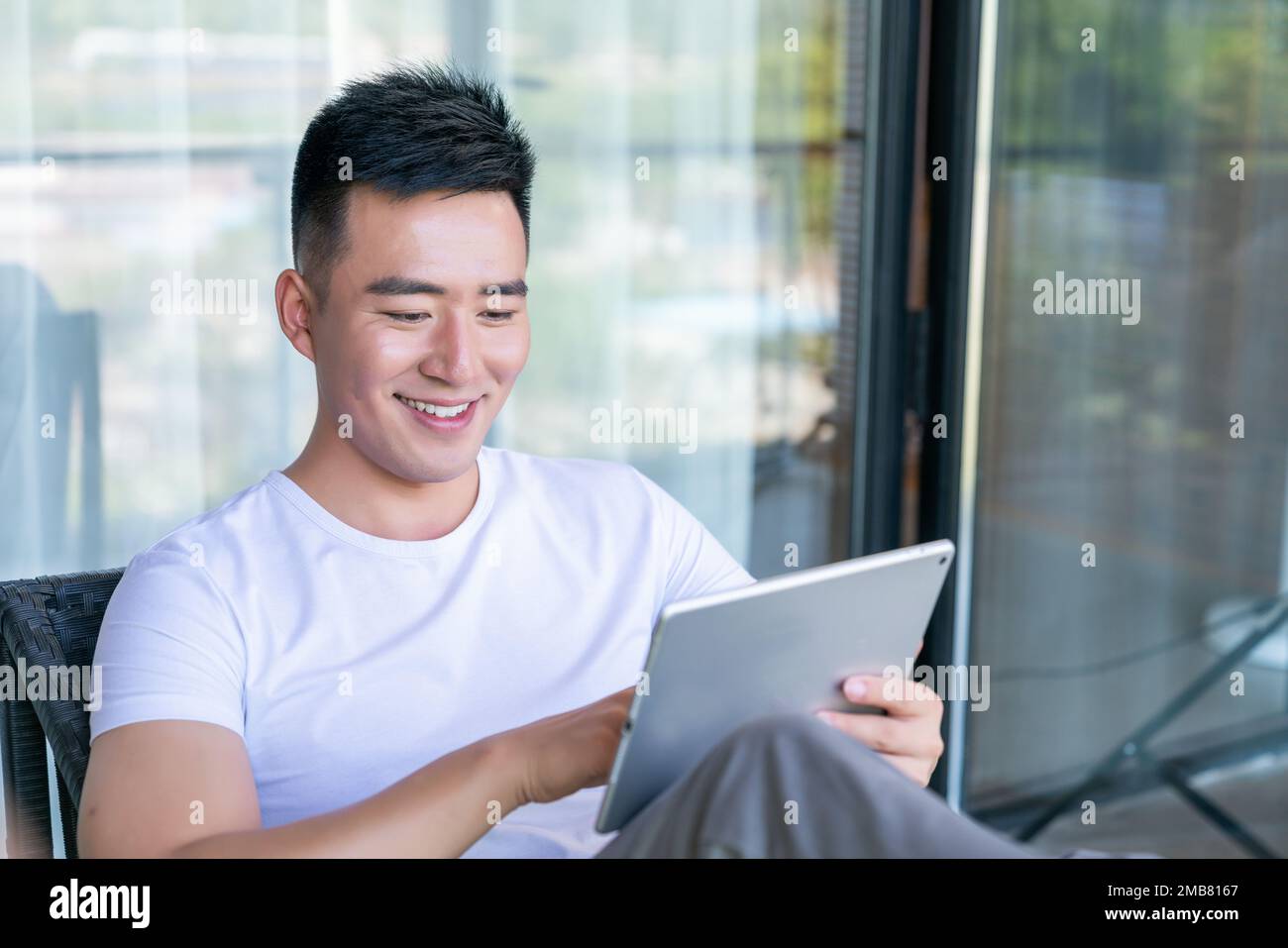 The young man use tablets Stock Photo - Alamy