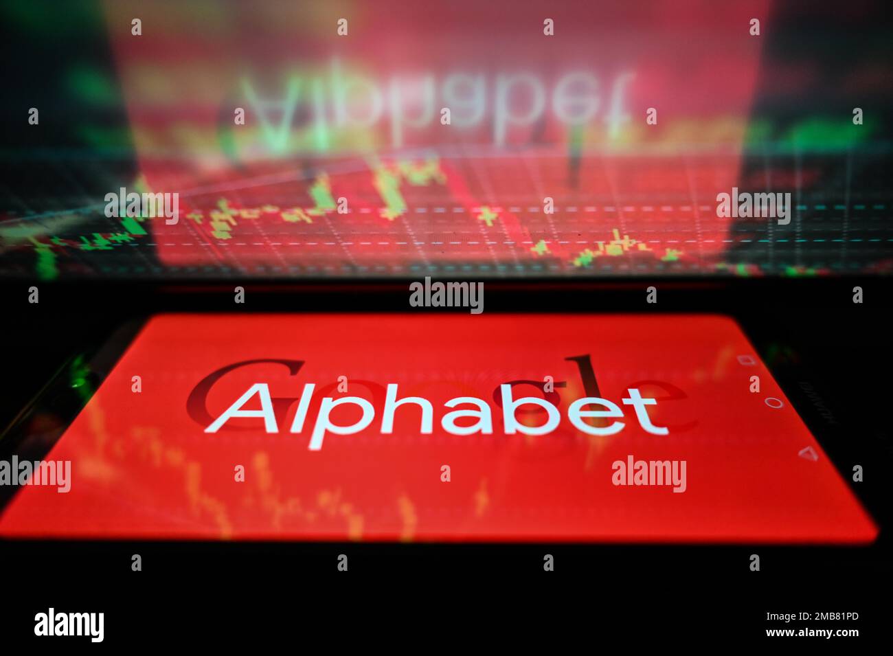 In this photo illustration, the Google's Alphabet logo seen displayed on a smartphone with stock ...