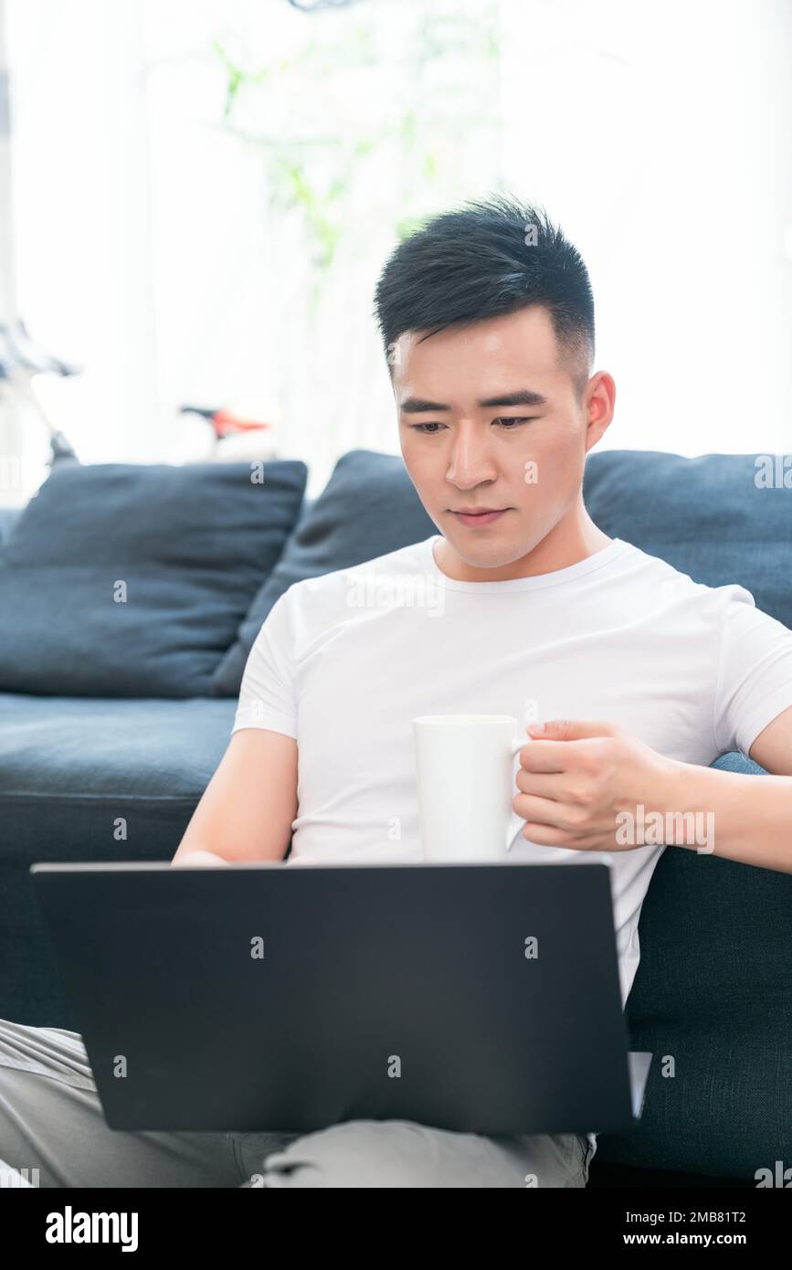 Young men who use a computer Stock Photo - Alamy