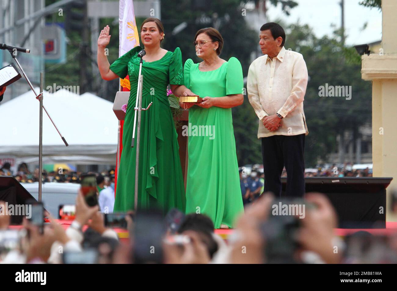 Sara Duterte, left, takes her oath as vice president beside her parents ...