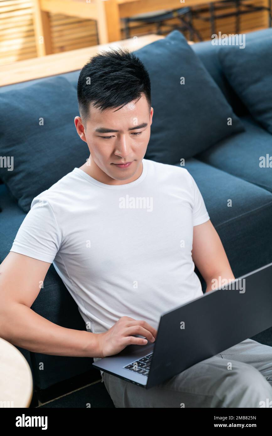 Young men who use a computer Stock Photo - Alamy