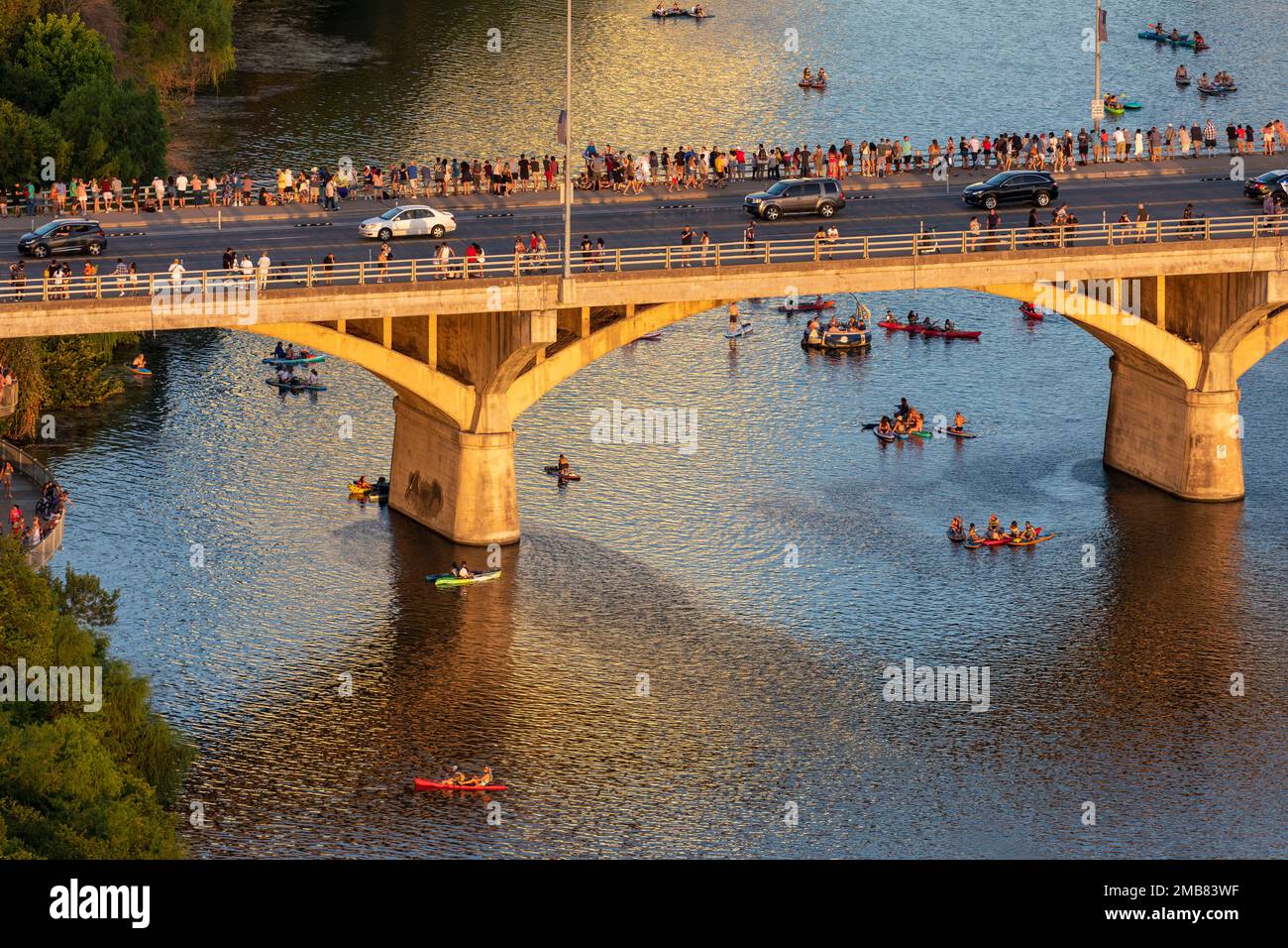 Tourists gather near sunset on Ann W. Richards Congress Street Bridge ...