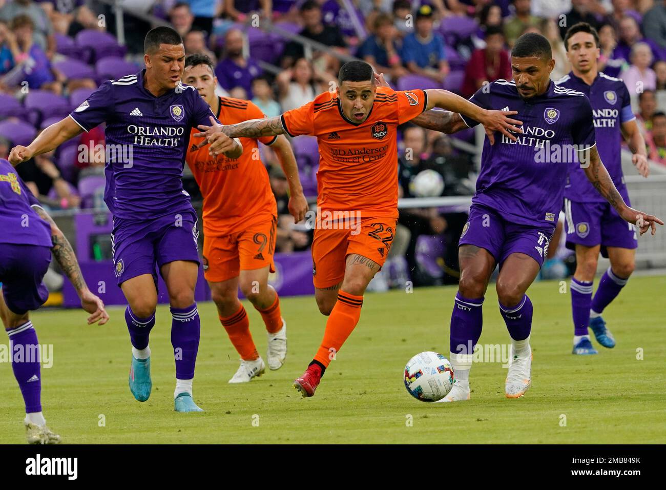 Houston Dynamo's Matias Vera (22) moves the ball between Orlando City's ...