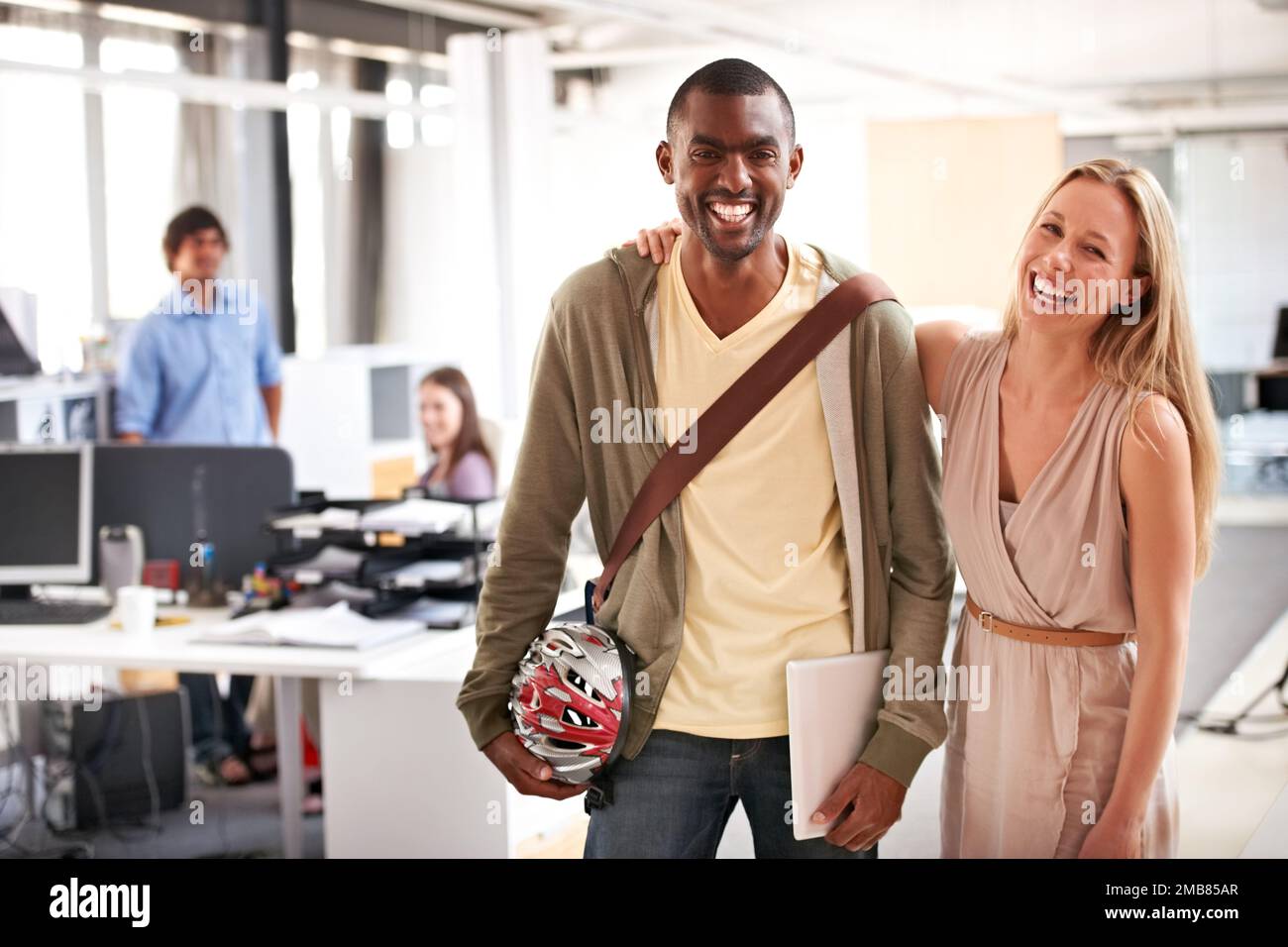 Good vibes in the work place. Two friendly business colleagues standing ...