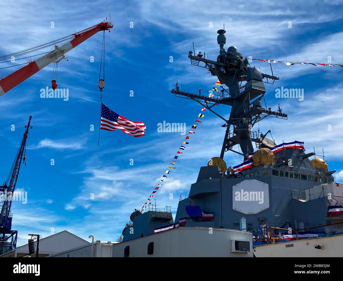 The superstructure of the future USS Basilone and a crane are seen on ...