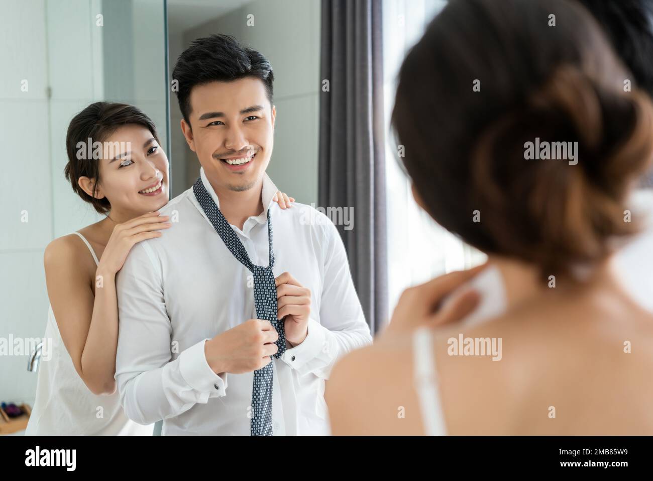 Young lovers look in the mirror Stock Photo - Alamy
