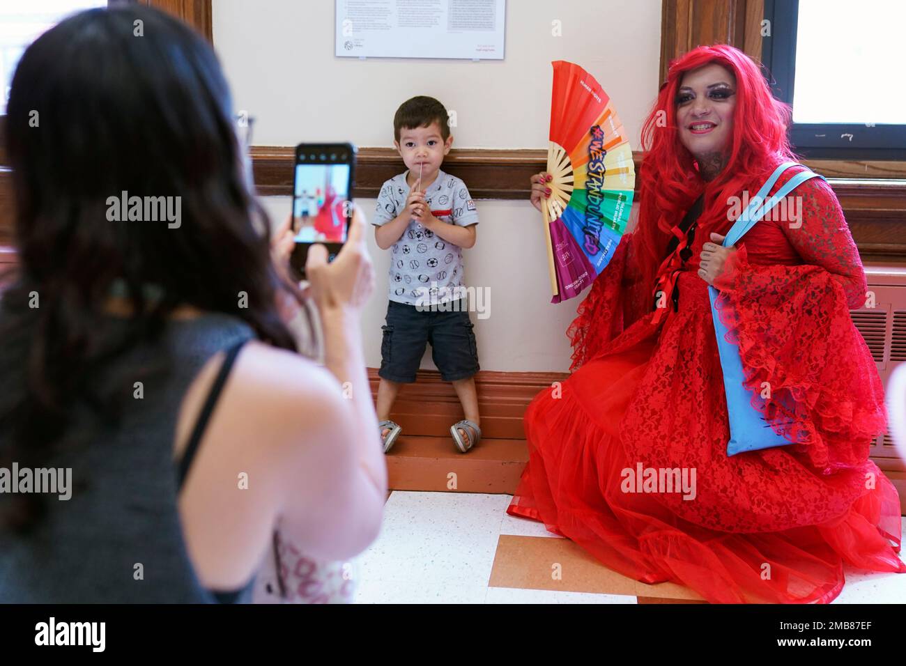 A drag queen who goes by the name Flame poses for a picture with Thomas ...