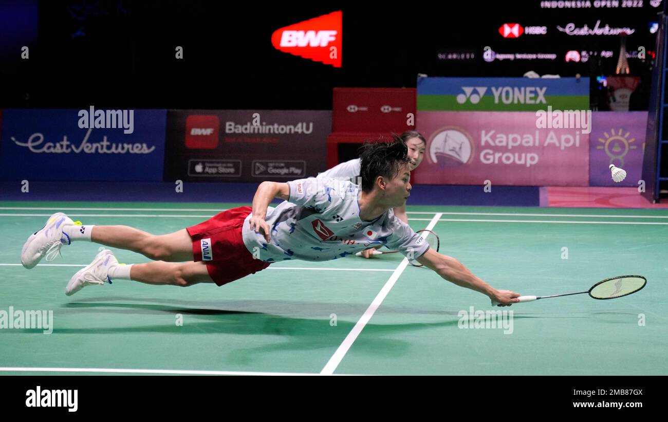 Japan's Yuta Watanabe dives to return the shuttlecock while his pair ...
