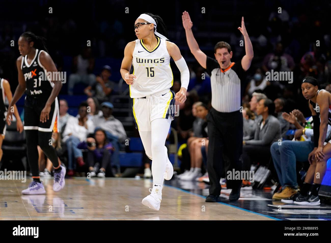 Dallas Wings guard Allisha Gray (15) jogs upcourt after sinking a 3 ...