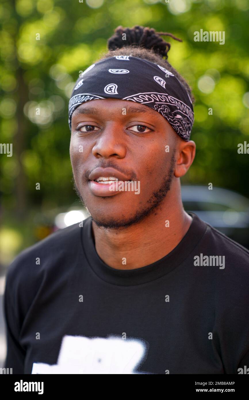KSI poses for a photographer whilst on an open top bus traveling ...