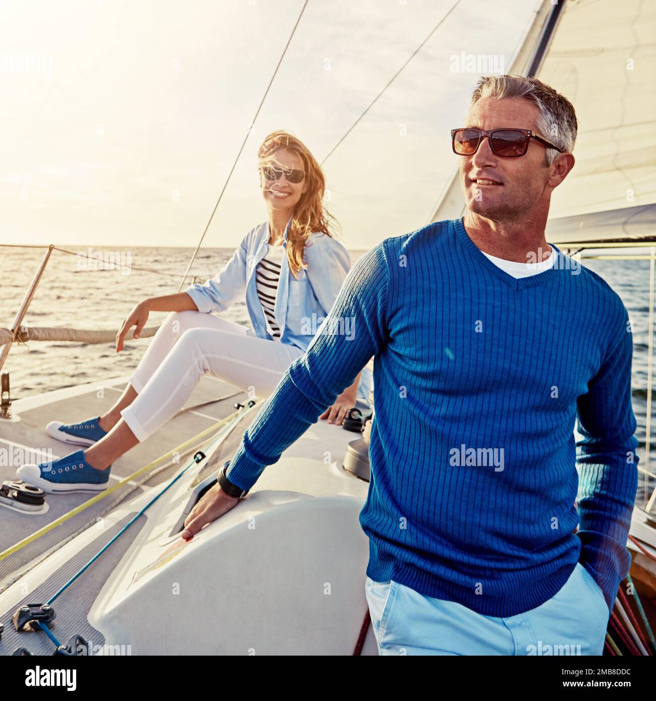 Mature, happy couple or retirement sailing yacht on ocean, sea or water ...