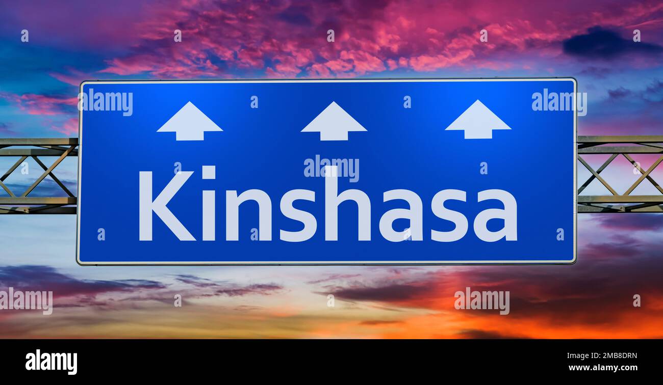 Road sign indicating direction to the city of Kinshasa Stock Photo - Alamy