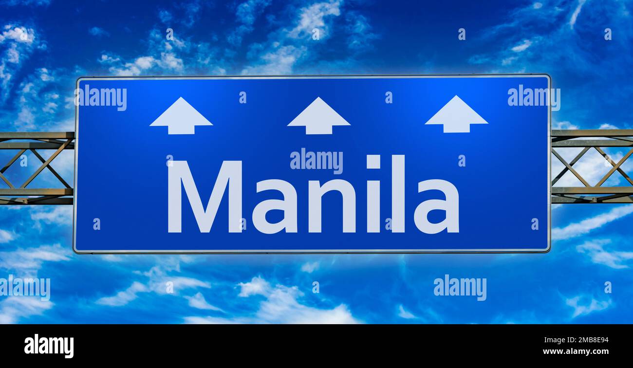 Road sign indicating direction to the city of Manila Stock Photo - Alamy