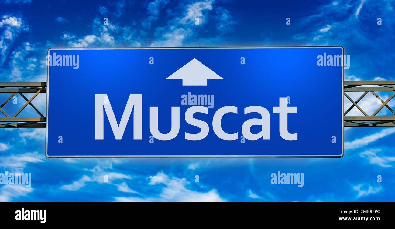 Road sign indicating direction to the city of Muscat Stock Photo - Alamy