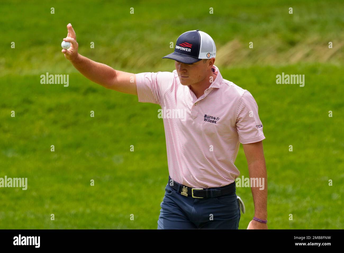 Austin Greaser reacts after a putt on the 12th hole during the first ...
