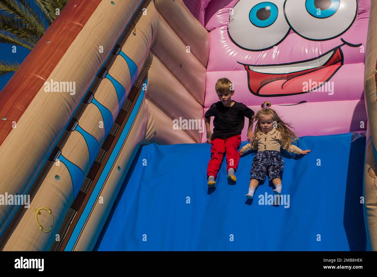 Kids having fun and sliding and jumping on outdoor playground. Kids ...