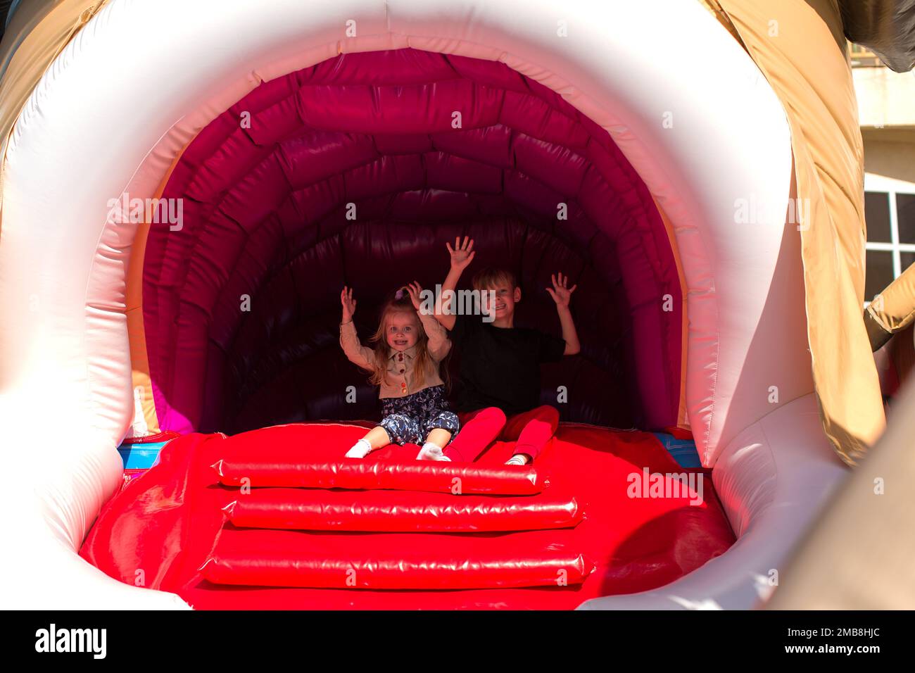 Kids having fun and sliding and jumping on outdoor playground. Kids ...