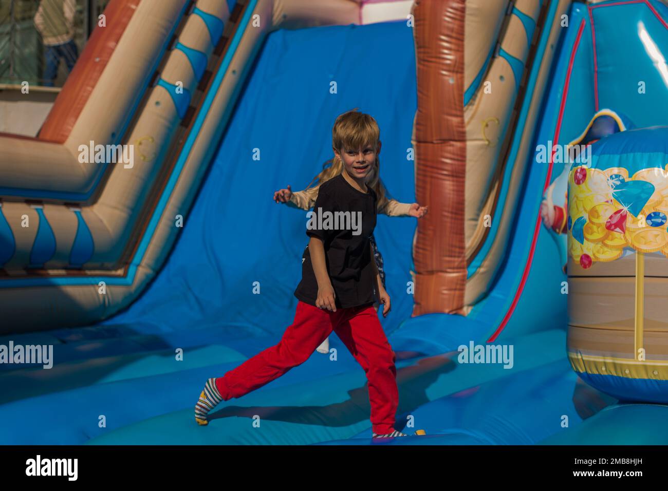Kids having fun and sliding and jumping on outdoor playground. Kids ...