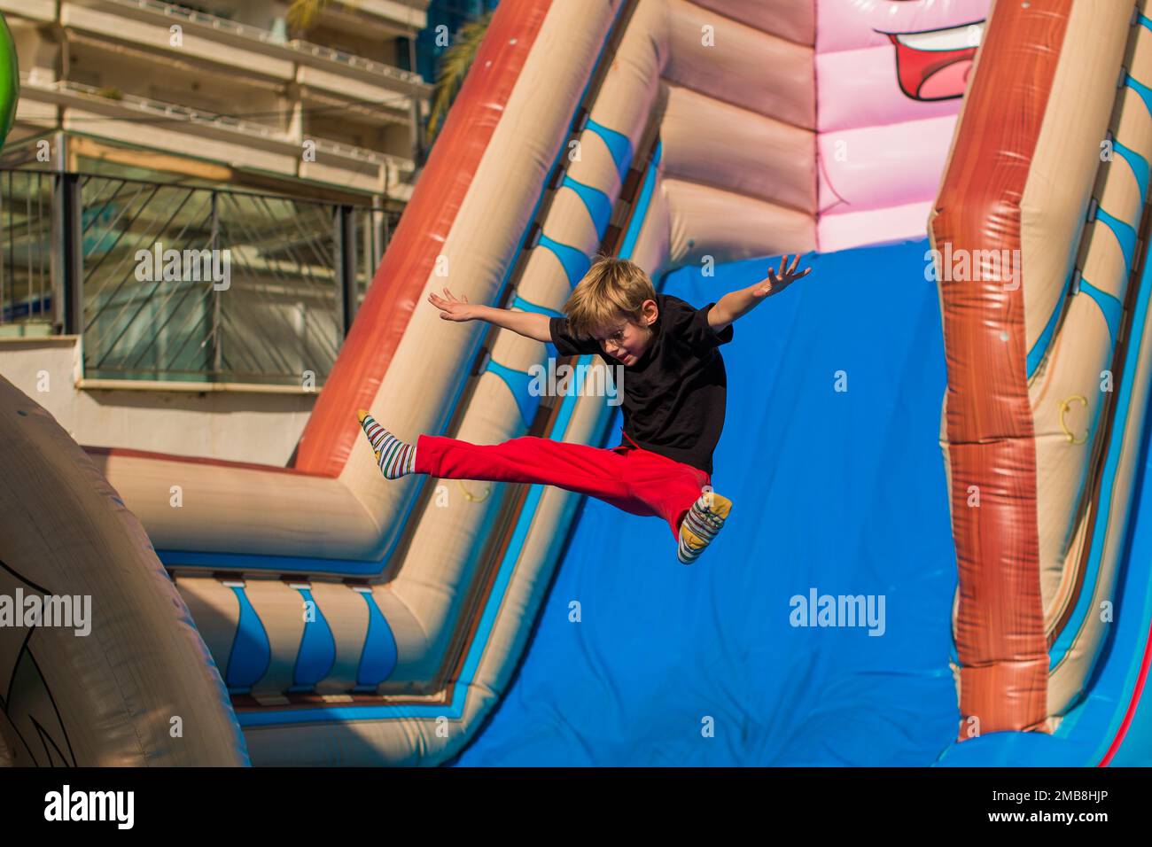 Kids having fun and sliding and jumping on outdoor playground. Kids ...