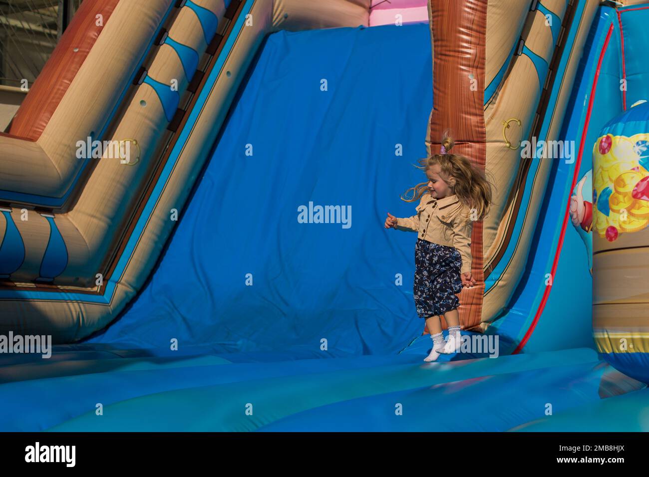Kids having fun and sliding and jumping on outdoor playground. Kids ...
