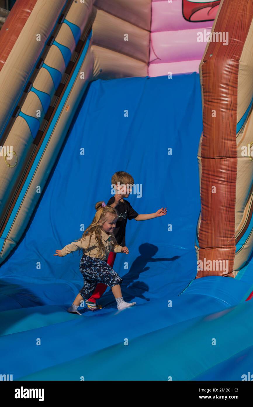 Kids having fun and sliding and jumping on outdoor playground. Kids ...