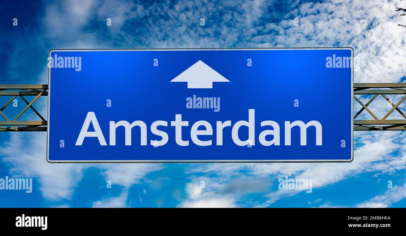 Road sign indicating direction to the city of Amsterdam Stock Photo - Alamy