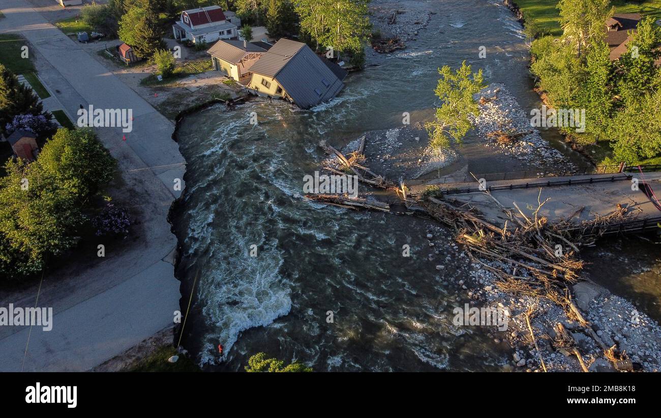 A house sits in Rock Creek after floodwaters washed away a road and a ...