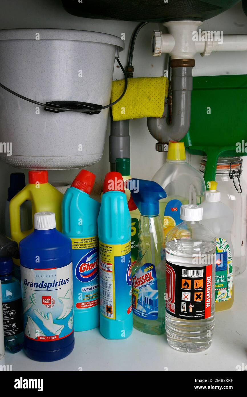 cleaning supplies in kitchen cupboard Stock Photo - Alamy