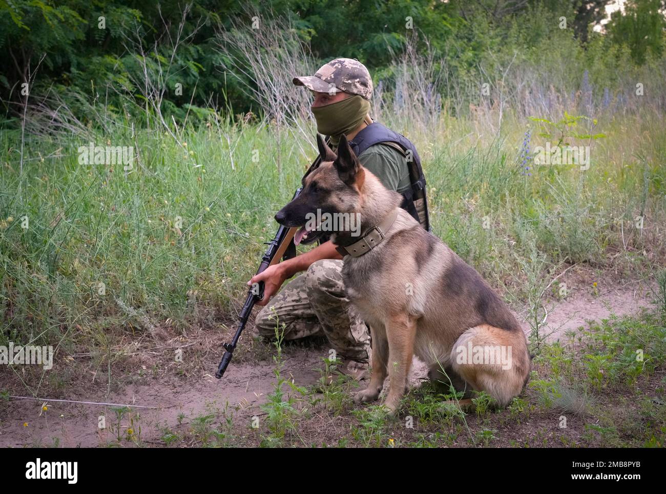 A soldier of Ukraine's special operations unit and his dog check a ...