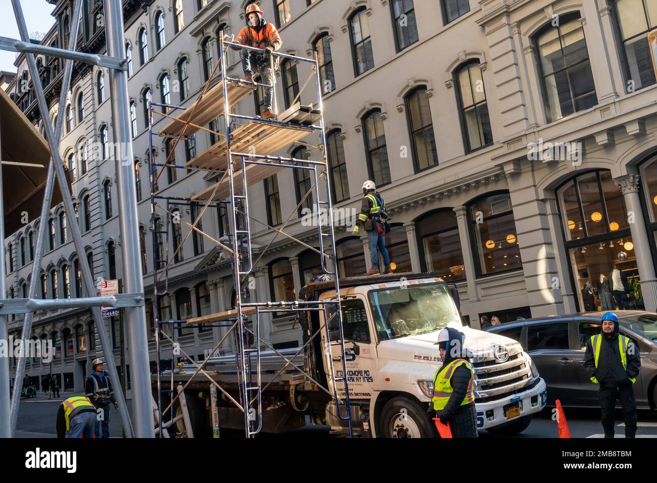 Workers construct scaffolding for facade work in Chelsea in New York on ...