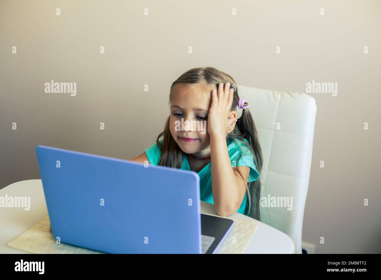 Little cute girl uses laptop to have video call Stock Photo - Alamy