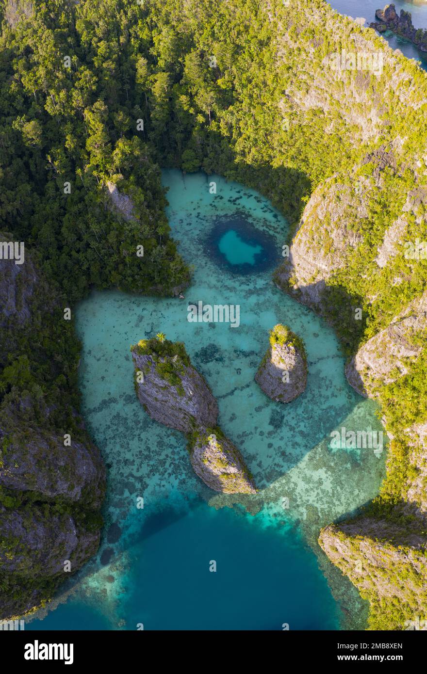 Rock islands, composed of limestone, rise from the tropical seascape in ...