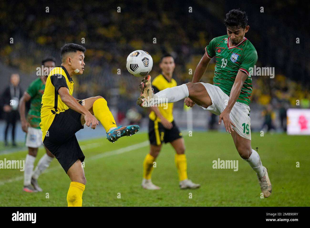Malaysia's Arif Aiman Hanapi, left, fights for the ball with Bangladesh ...
