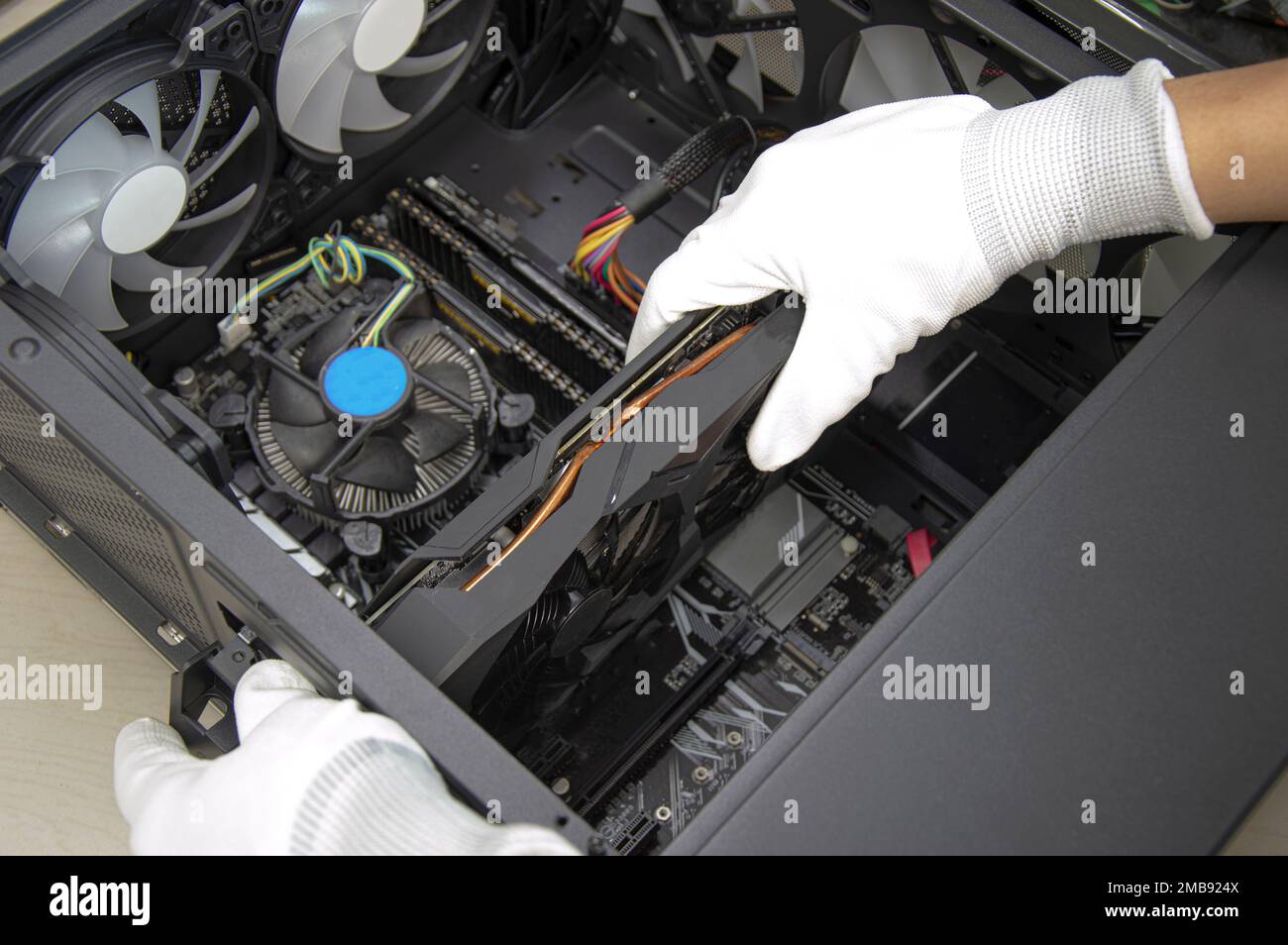 top view mechanic installing graphics card Stock Photo - Alamy