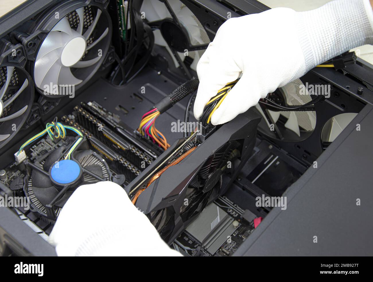 top view mechanic installing graphics card Stock Photo - Alamy