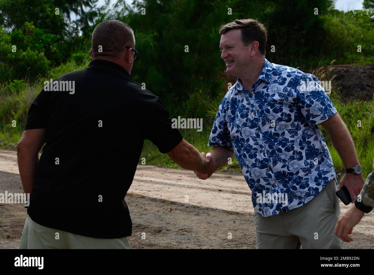 U.S. Ambassador to Palau John Hennessy-Niland shakes hands with an Army ...