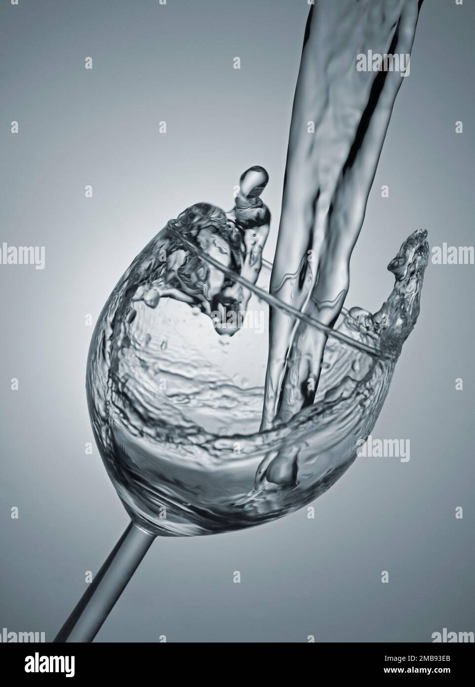 A rush of water pouring into a glass Stock Photo - Alamy
