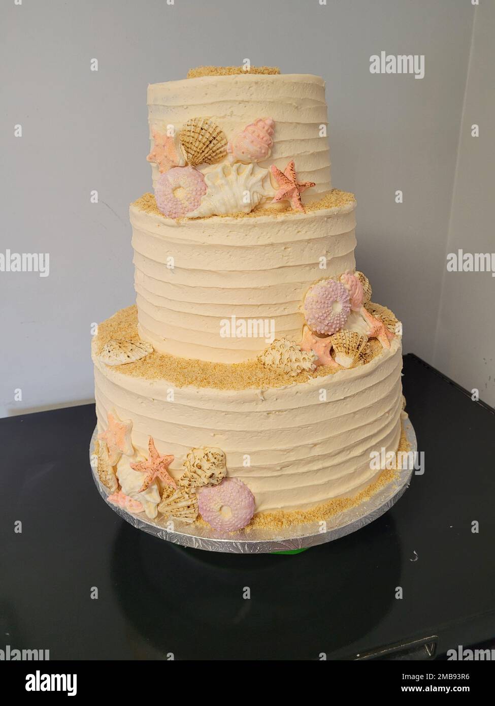 A sweet and tasty cake with big cream decorated with edible seashell ...