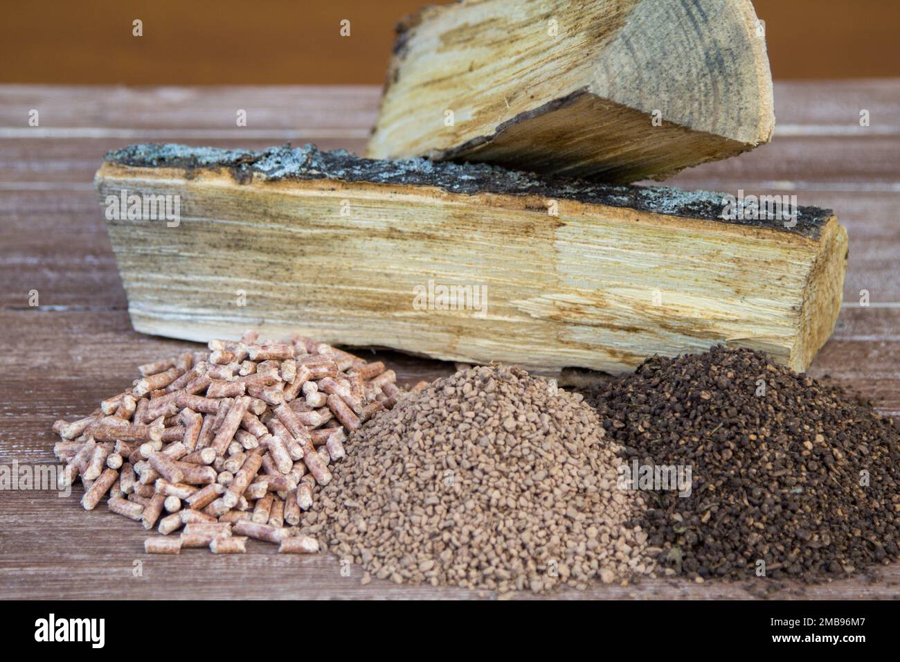Image of wooden logs and piles of pellets, peanuts and olive pomace ...