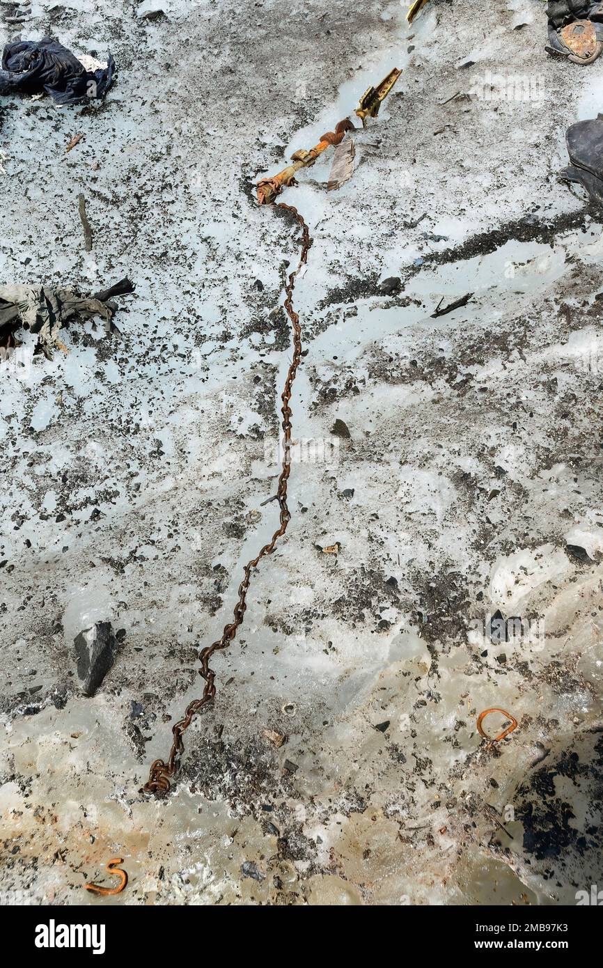 A rusted chain lies in the debris field left on Colony Glacier amid the ...