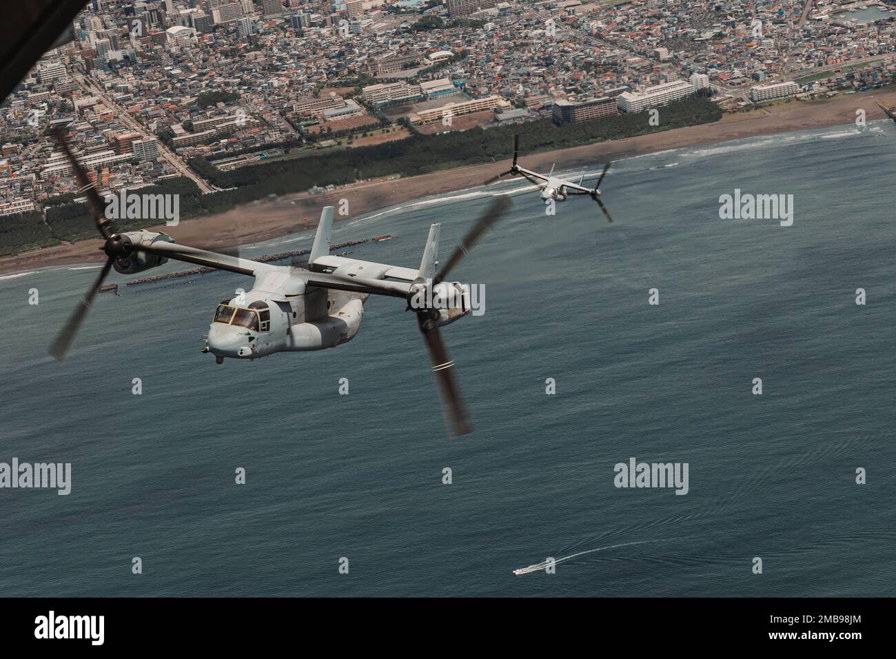 U.S. Marine Corps MV-22B Ospreys, assigned to Marine Medium Tiltrotor Squadron (VMM) 265, fly in ...